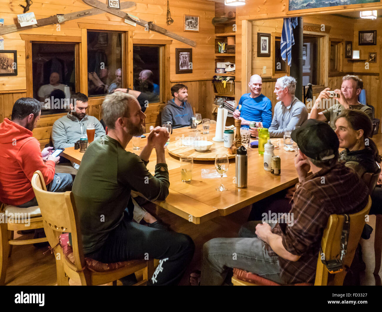 Back country skiers relax inside remote Mount Carlyle Lodge; Selkirk ...