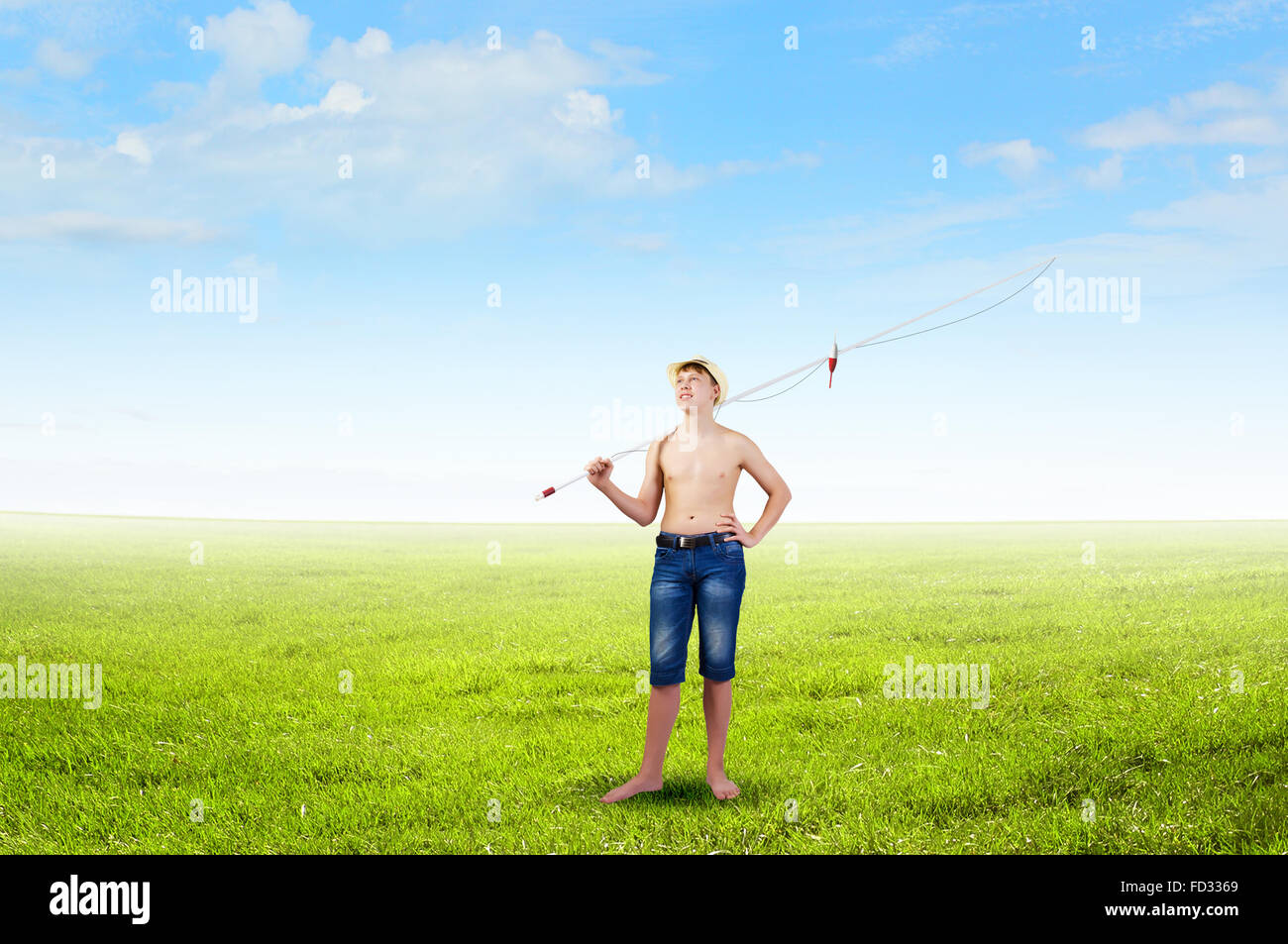 Young boy with fishing rod on shoulder Stock Photo - Alamy