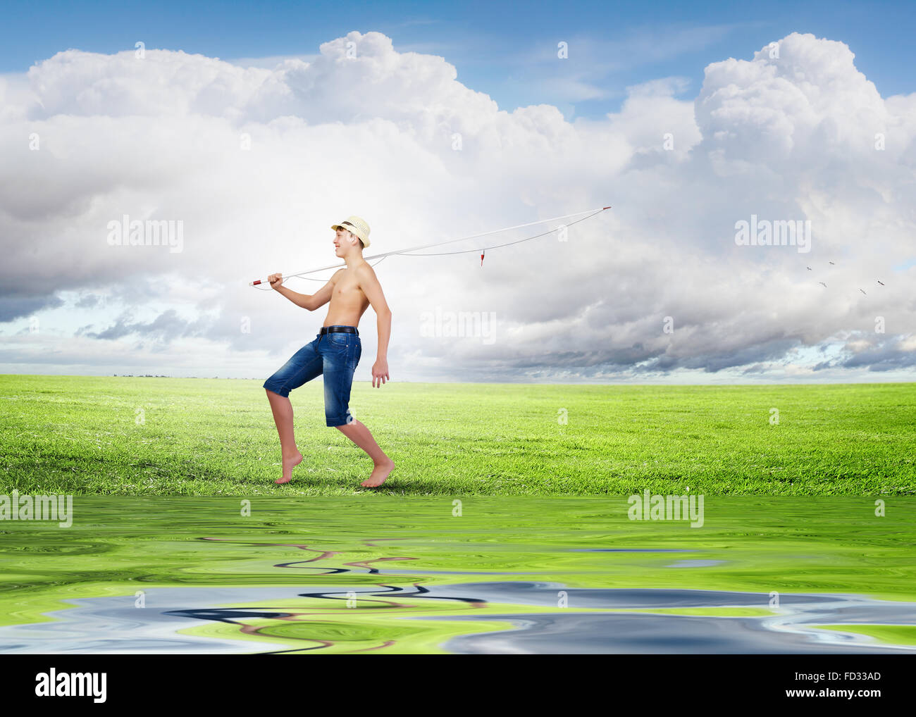Young boy walking with fishing rod on shoulder Stock Photo - Alamy