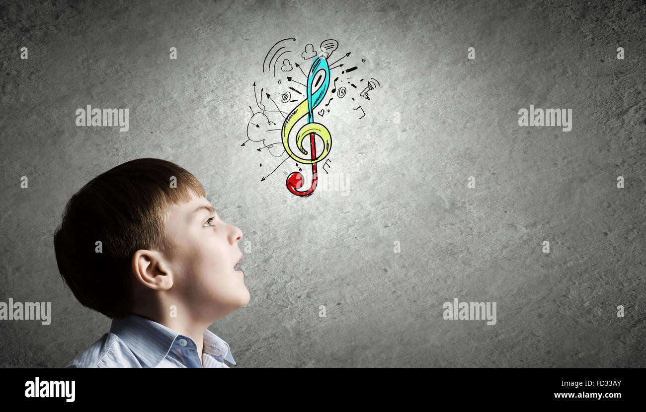 Cute boy of school age and music symbol Stock Photo - Alamy