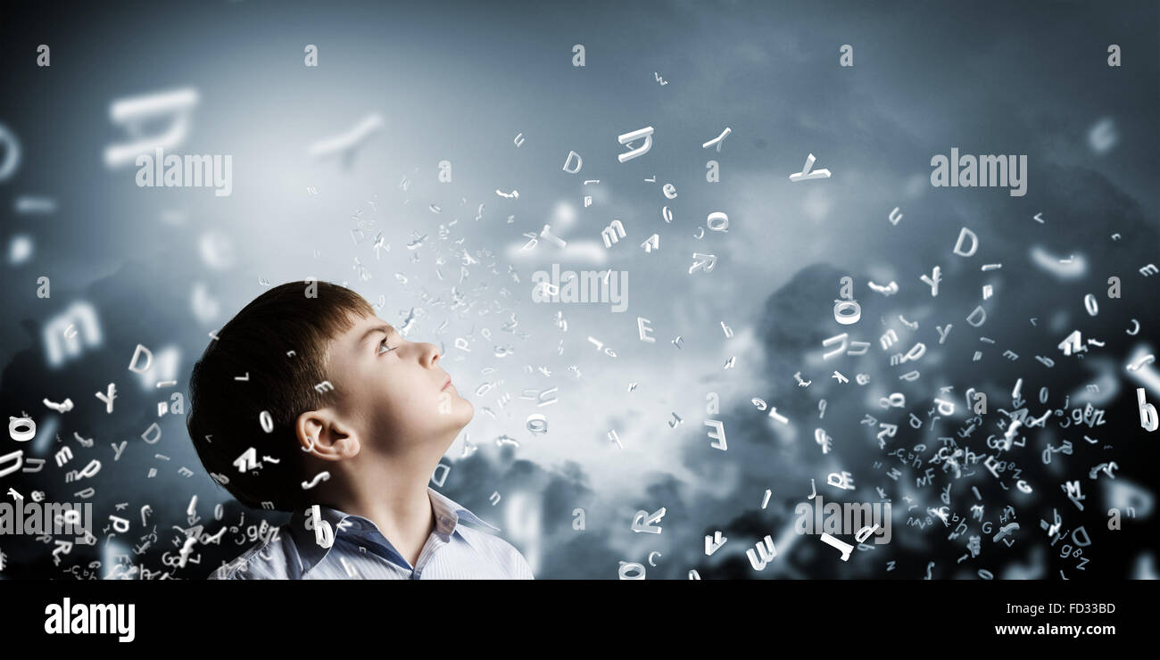 Cute boy of school age and letters flying around Stock Photo - Alamy