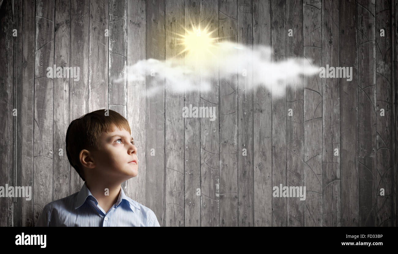 Cute boy of school age looking at sun above his head Stock Photo - Alamy