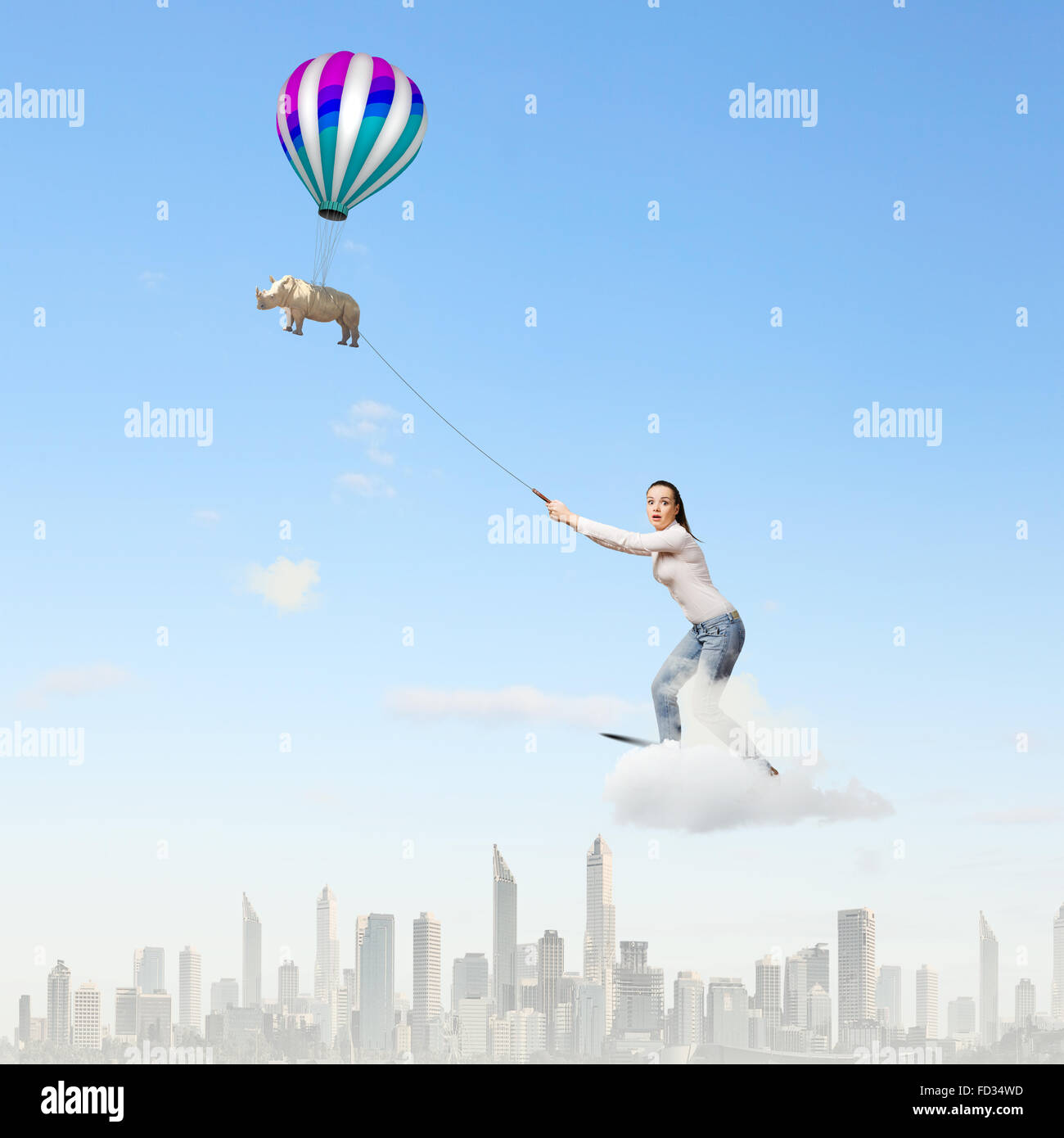 Young woman holding flying rhino on rope Stock Photo - Alamy