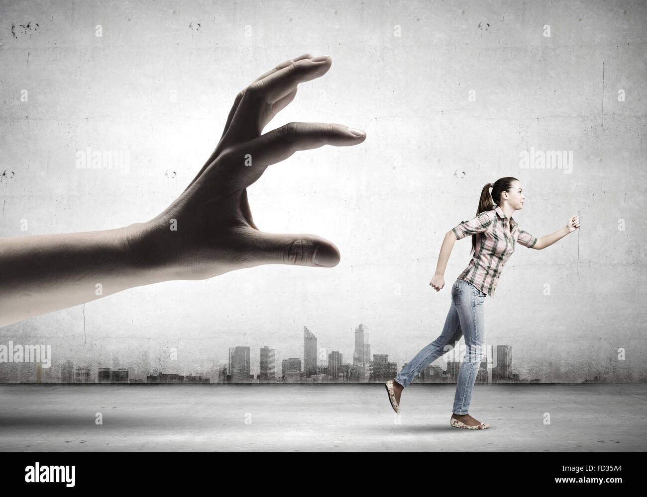 Young woman in casual running away from big hand Stock Photo - Alamy