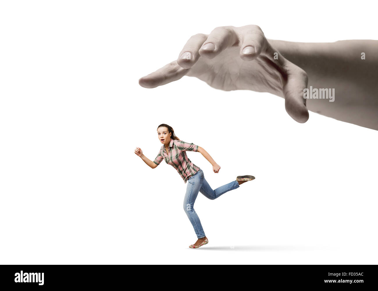 Young woman in casual running away from big hand Stock Photo - Alamy