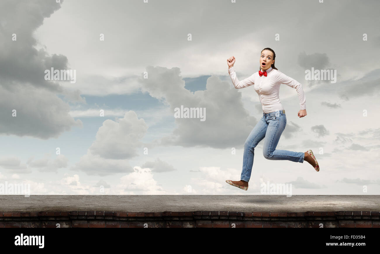 Young woman in casual running in a hurry Stock Photo - Alamy