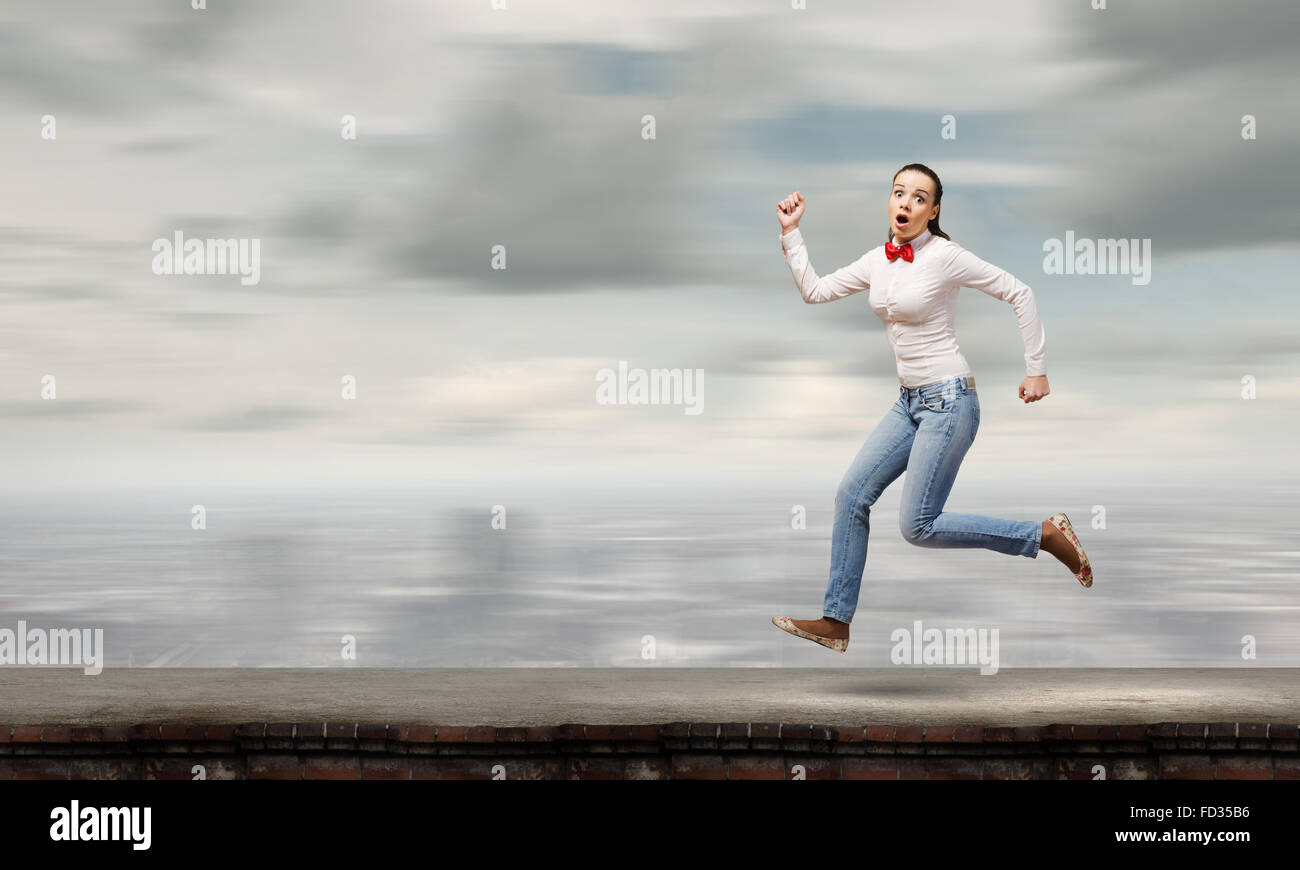 Young woman in casual running in a hurry Stock Photo - Alamy
