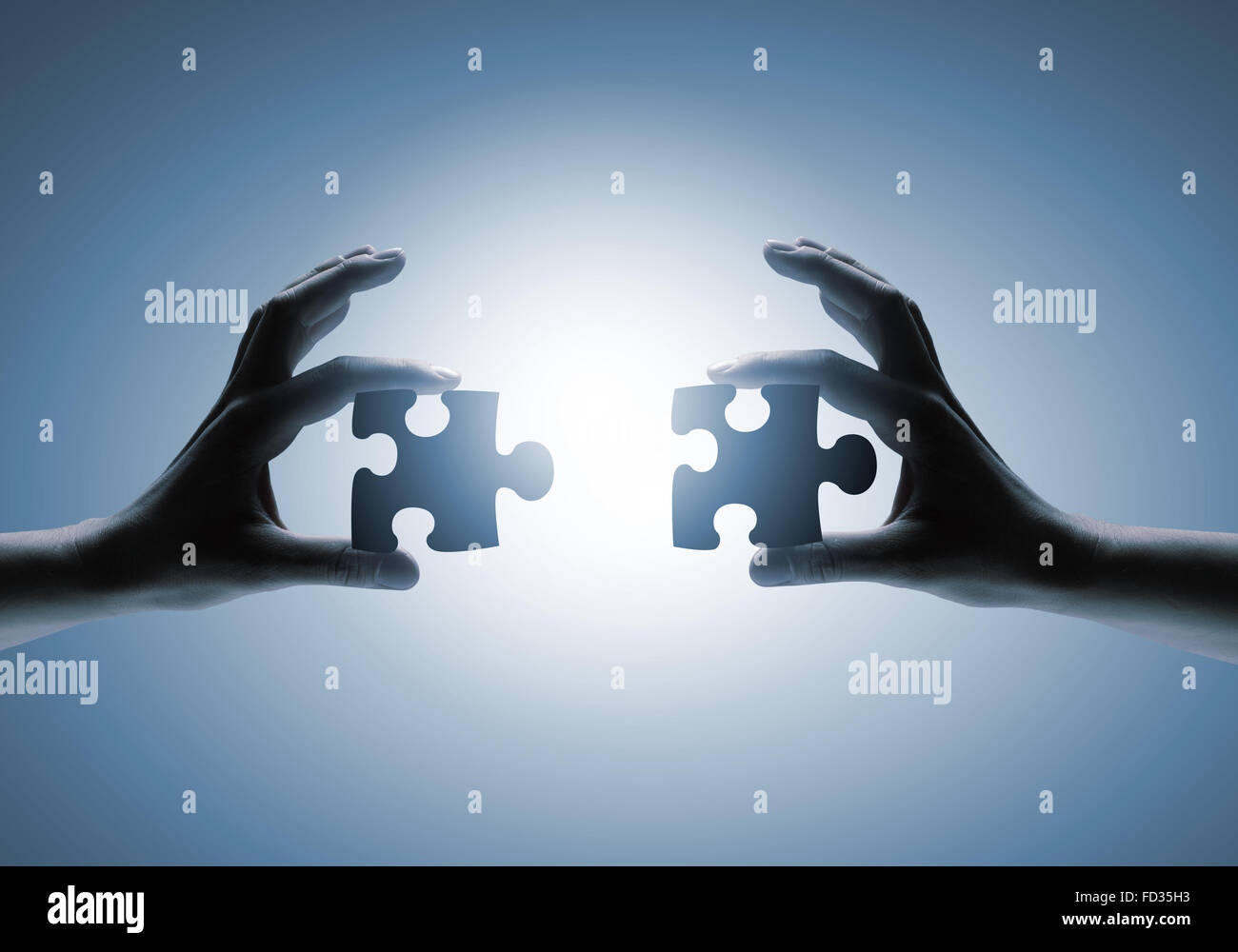 Close up of human hands connecting puzzle elements Stock Photo - Alamy