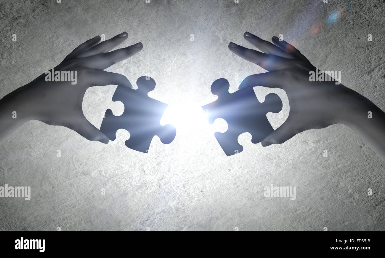 Close up of human hands connecting puzzle elements Stock Photo - Alamy