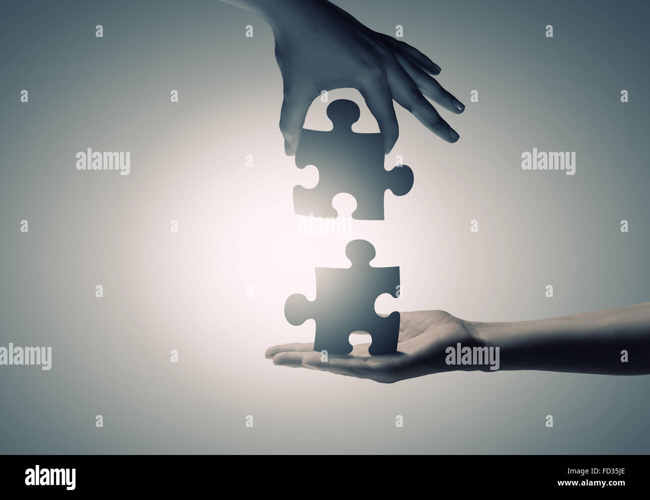 Close up of human hands connecting puzzle elements Stock Photo - Alamy