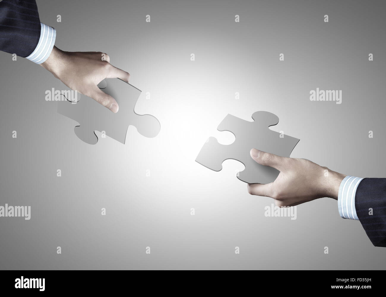 Close up of human hands connecting puzzle elements Stock Photo - Alamy