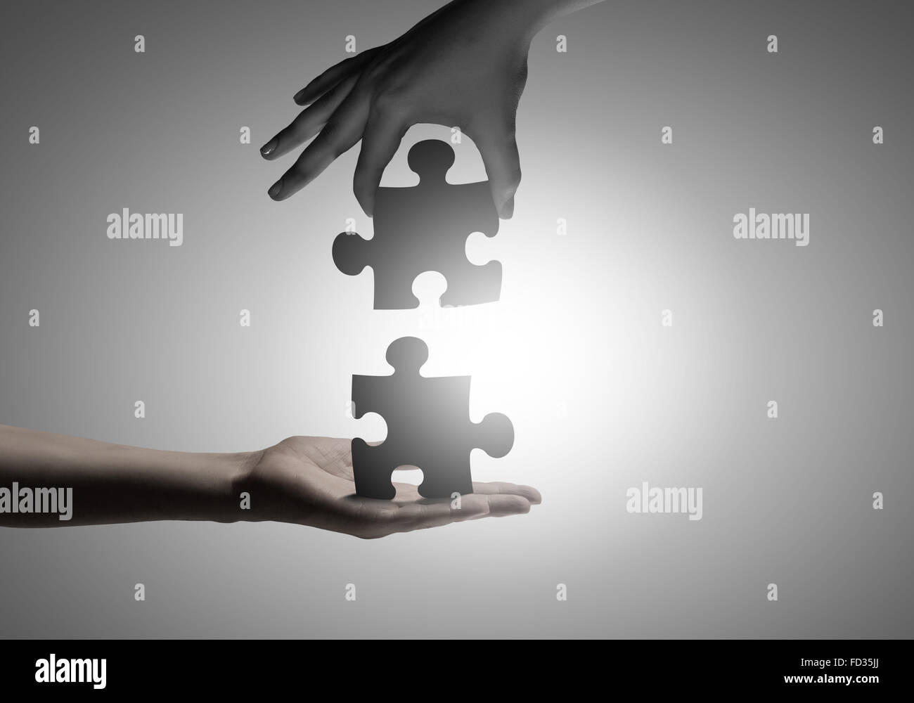 Close up of human hands connecting puzzle elements Stock Photo - Alamy