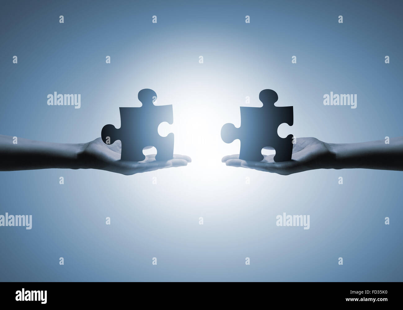 Close up of human hands connecting puzzle elements Stock Photo - Alamy