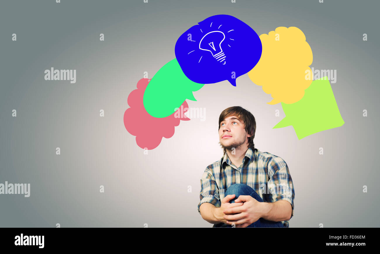Young man and colorful thoughts above her head Stock Photo - Alamy