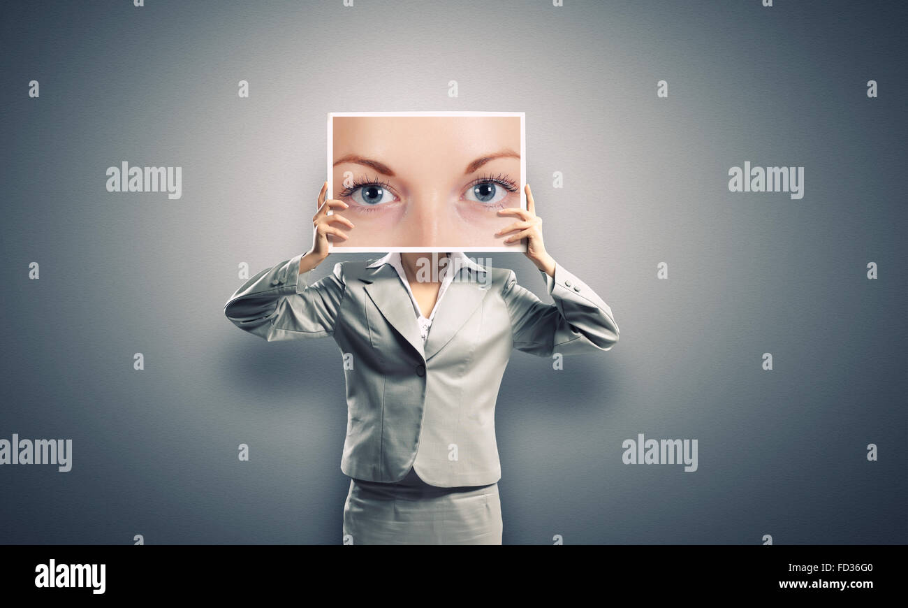 Unrecognizable businesswoman holding big photo with eyes Stock Photo ...