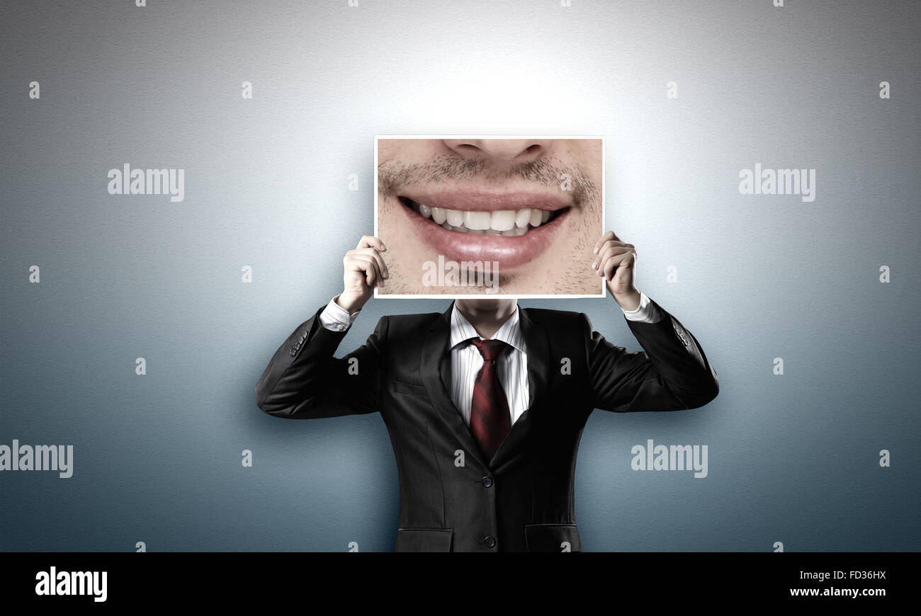 Unrecognizable businessman holding photo with smiling mouth Stock Photo ...