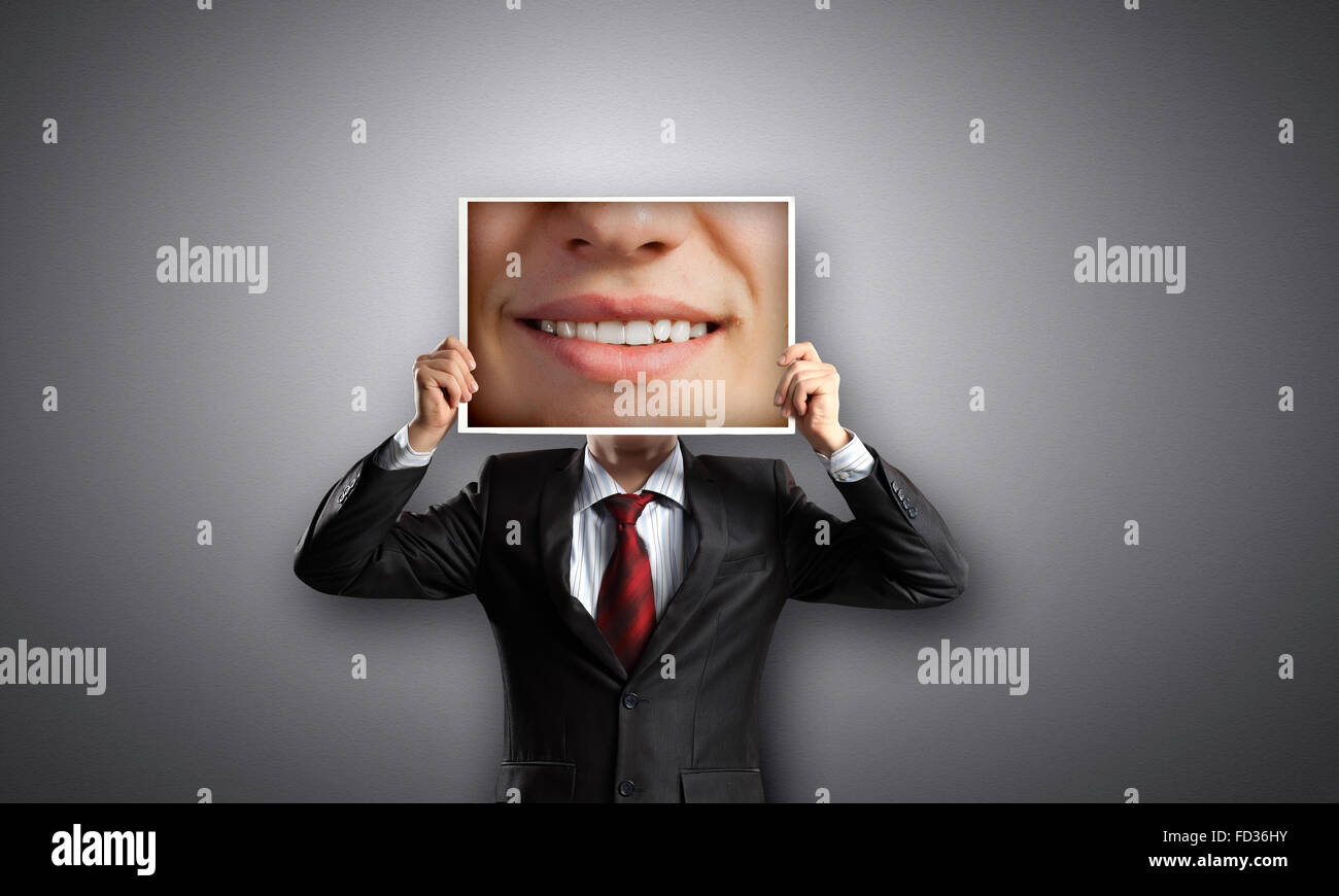 Unrecognizable businessman holding photo with smiling mouth Stock Photo ...