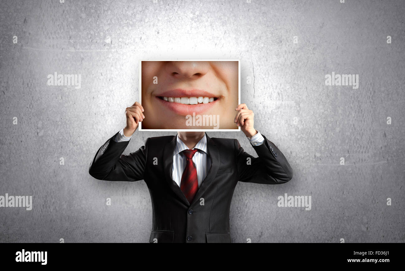 Unrecognizable businessman holding photo with smiling mouth Stock Photo ...