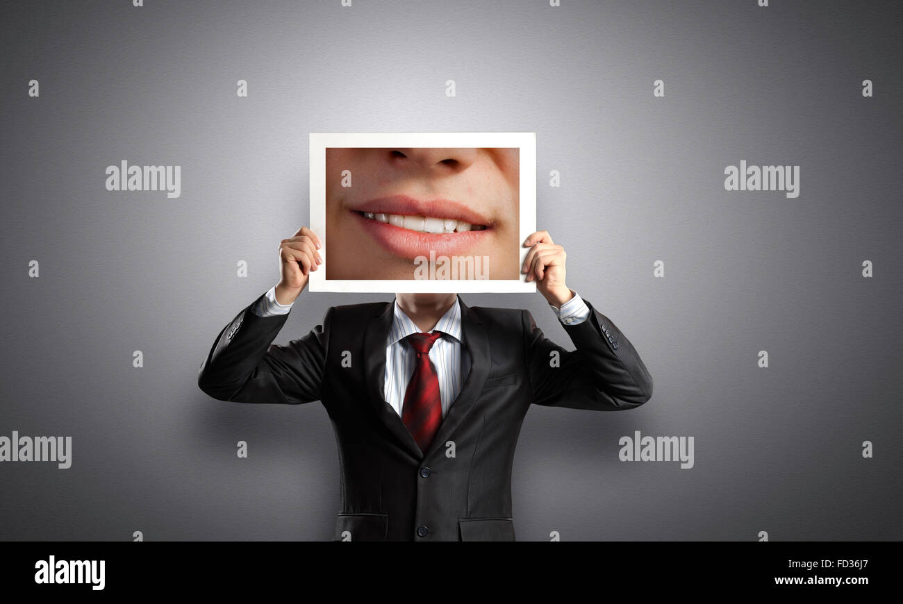 Unrecognizable businessman holding photo with smiling mouth Stock Photo ...