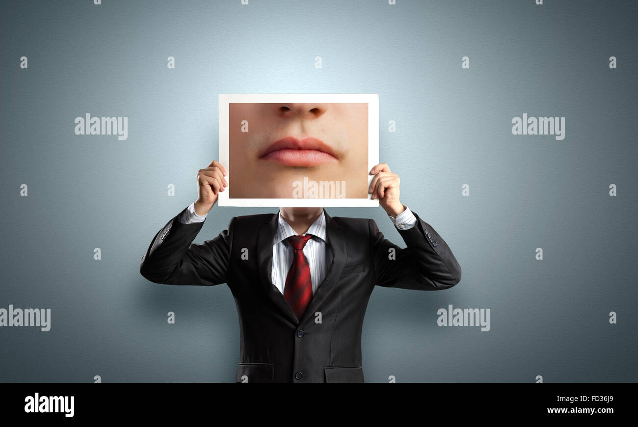Unrecognizable businessman hiding face behind photo of mouth Stock ...