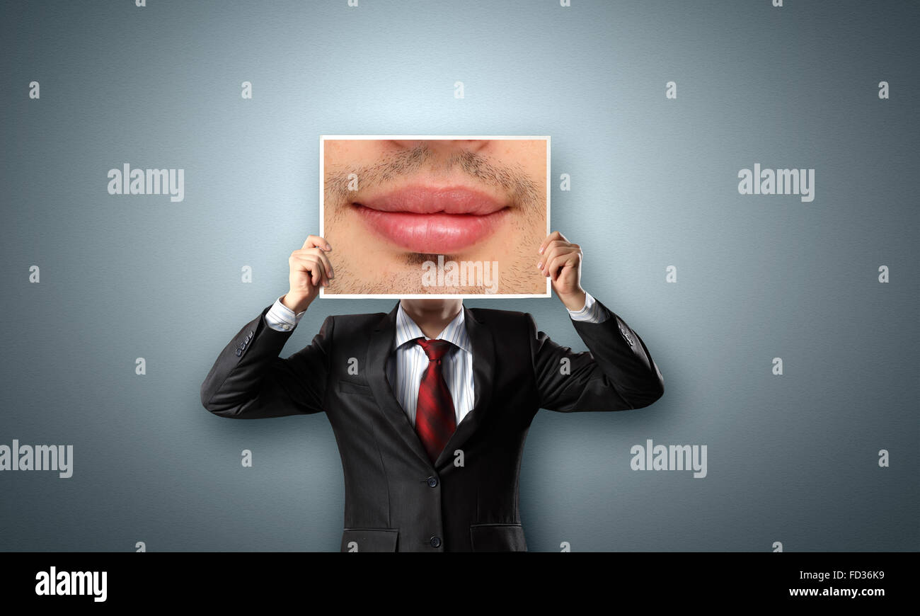Unrecognizable businessman hiding face behind photo of mouth Stock ...