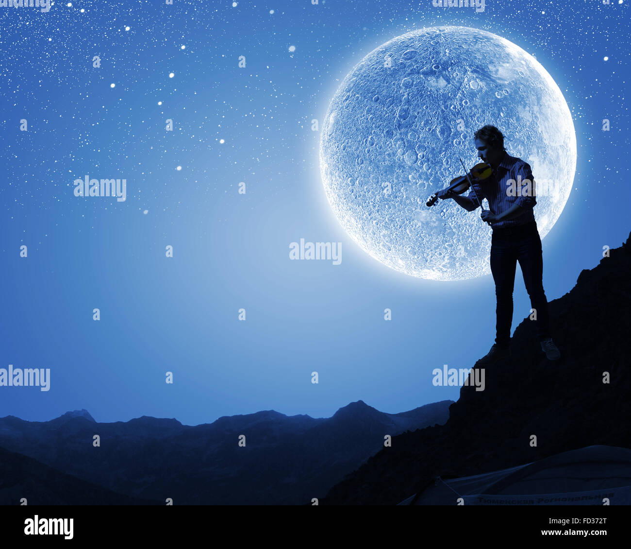 Young man playing violin at night under moon light Stock Photo - Alamy