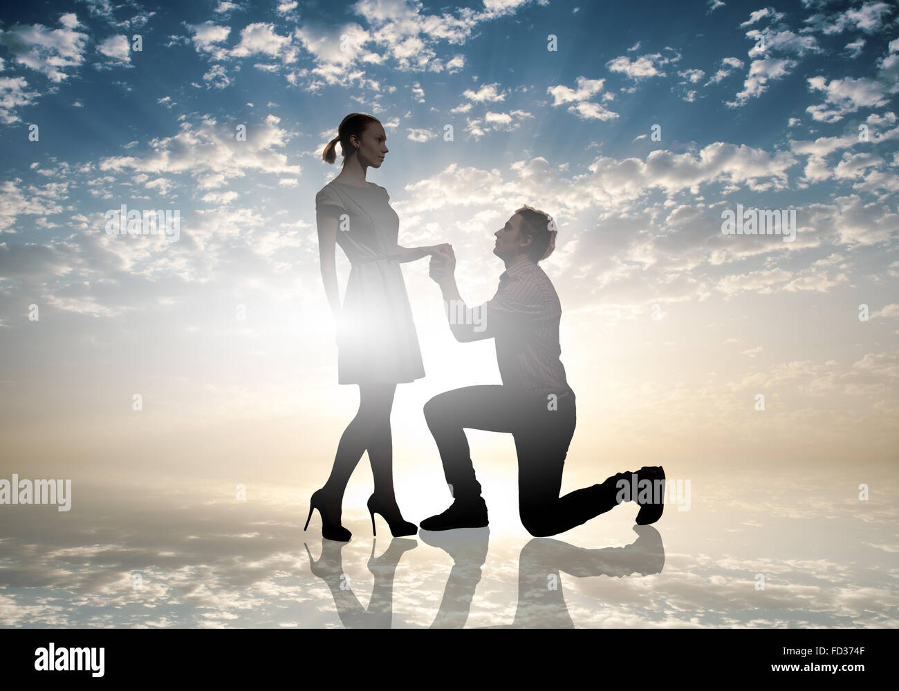 Young man standing on knees and proposing a woman Stock Photo - Alamy