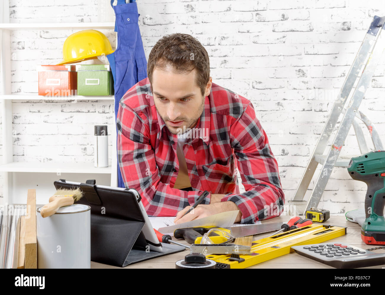 a attractive young man using the tablet for DIY Stock Photo - Alamy