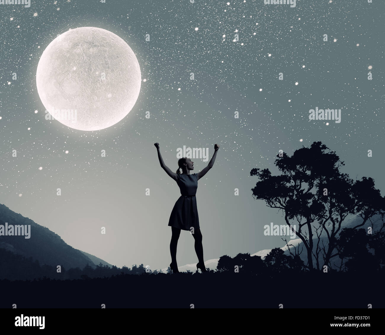 Silhouette of woman against full moon with hands up Stock Photo - Alamy