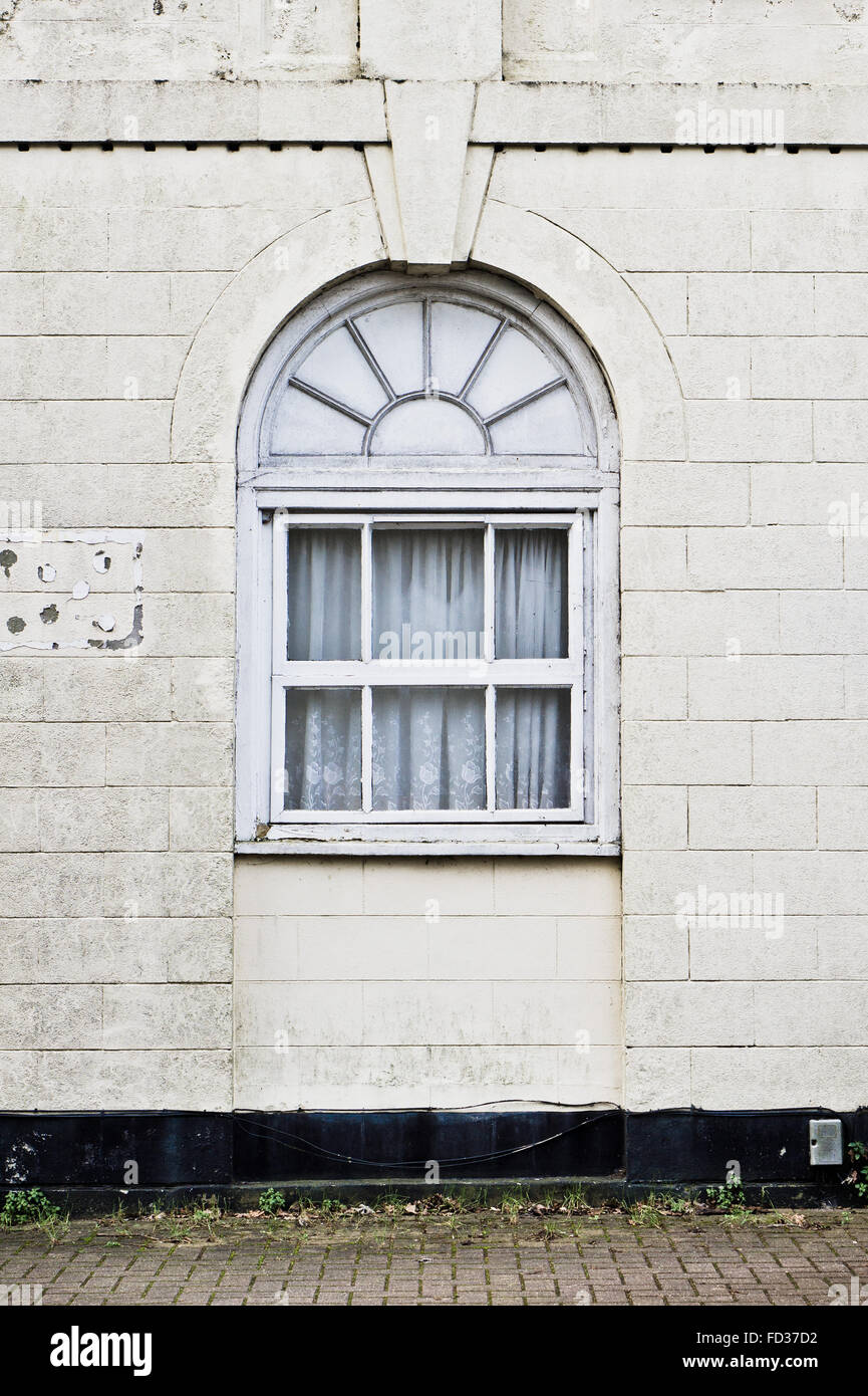 An arch shaped window in the exterior wall of an english building Stock ...