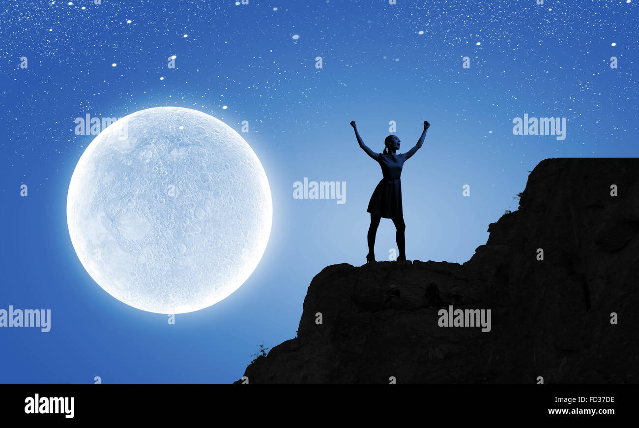 Silhouette of woman against full moon with hands up Stock Photo - Alamy