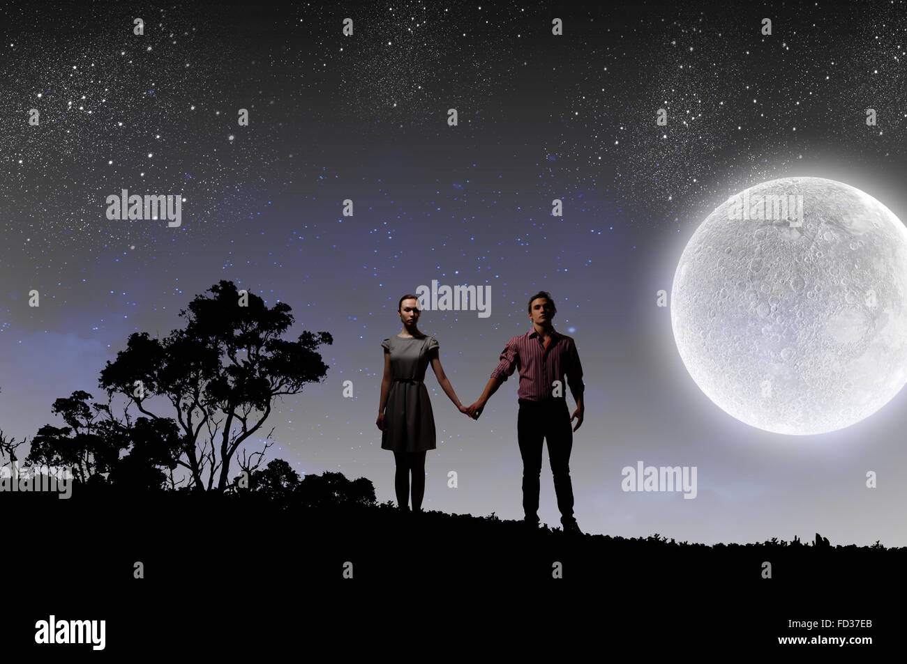 Silhouettes of young romantic couple standing under the moon light ...