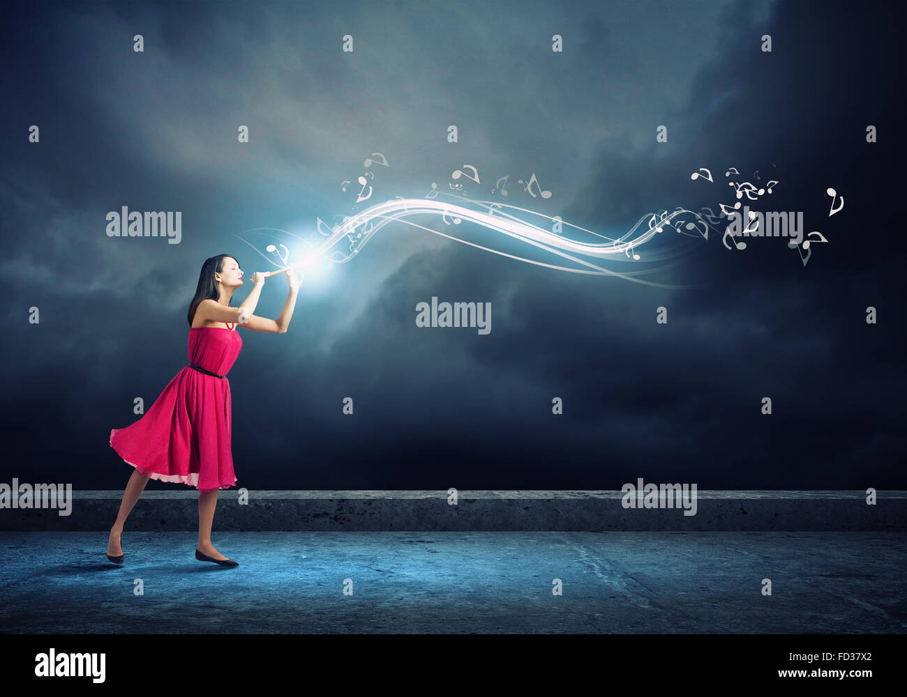 Young pretty woman in red dress playing flute Stock Photo - Alamy