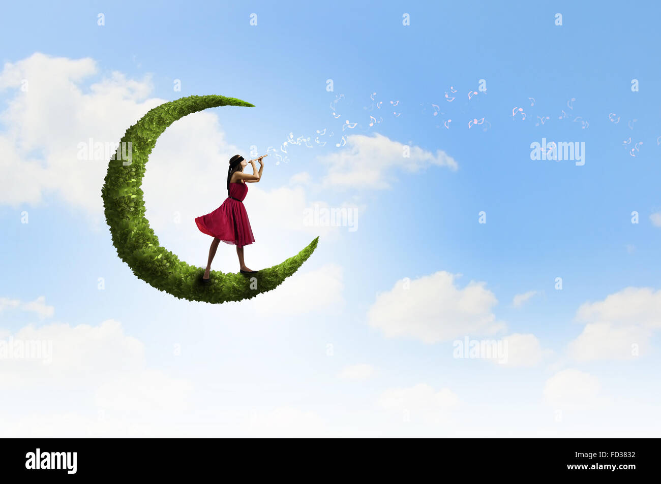 Young woman in red dress playing flute Stock Photo - Alamy