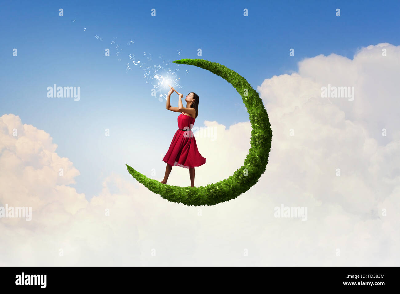 Young woman in red dress playing flute Stock Photo - Alamy