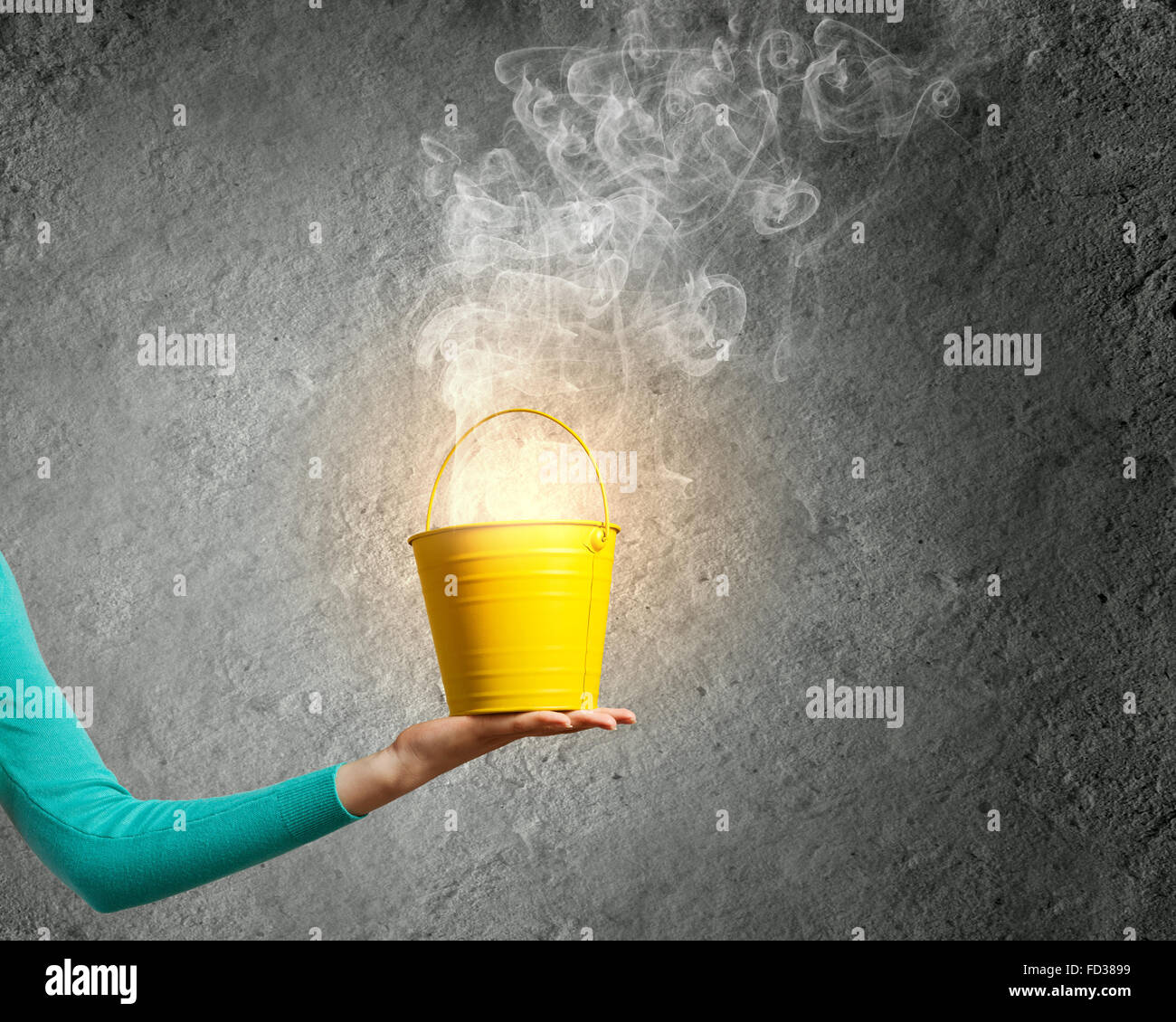 Close up of woman hand holding yellow bucket Stock Photo - Alamy