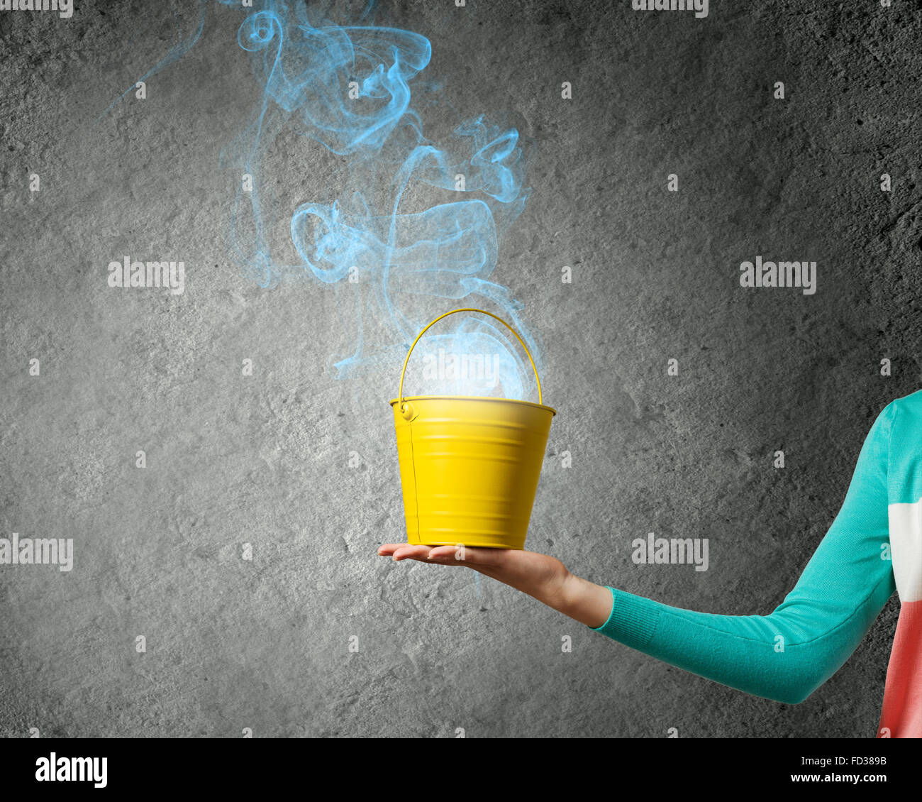 Close up of woman hand holding yellow bucket Stock Photo - Alamy