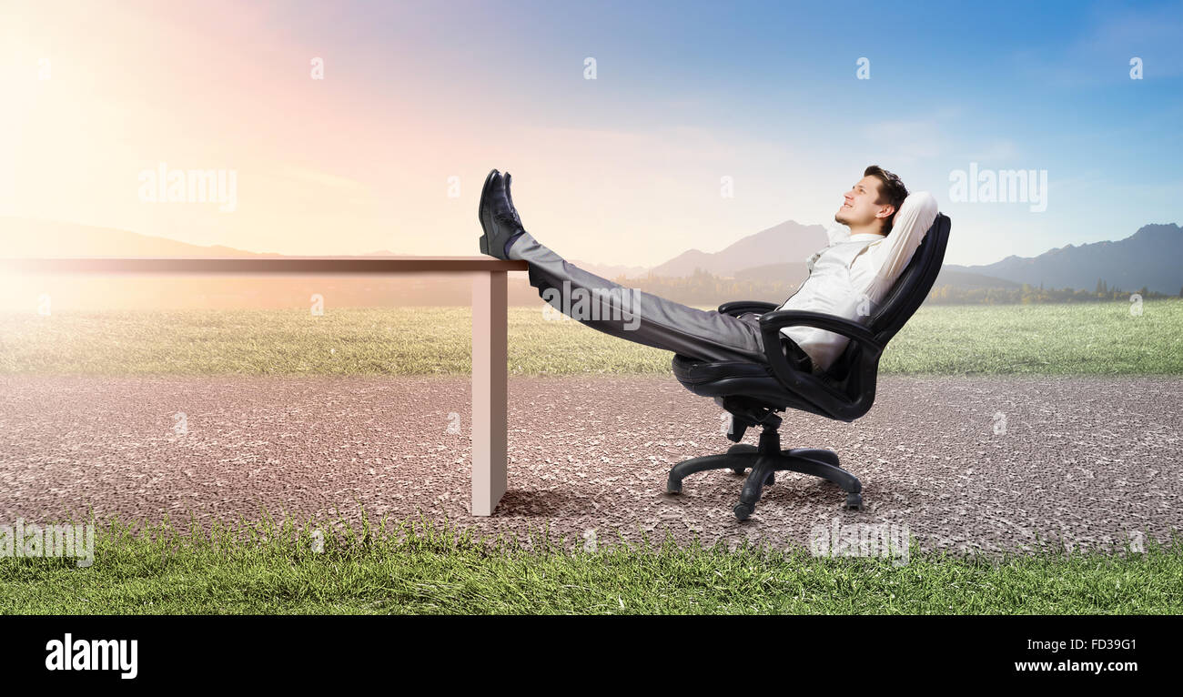 Young businessman sitting relaxed in chair with legs on table Stock ...