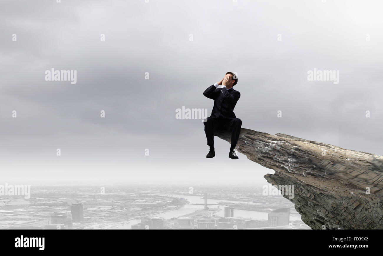 Young businessman on top of rock screaming in megaphone Stock Photo - Alamy