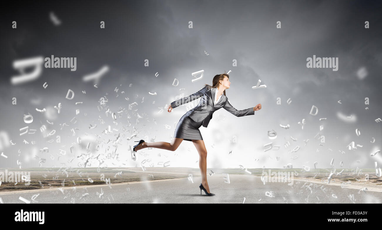 Young pretty businesswoman in suit running away Stock Photo - Alamy