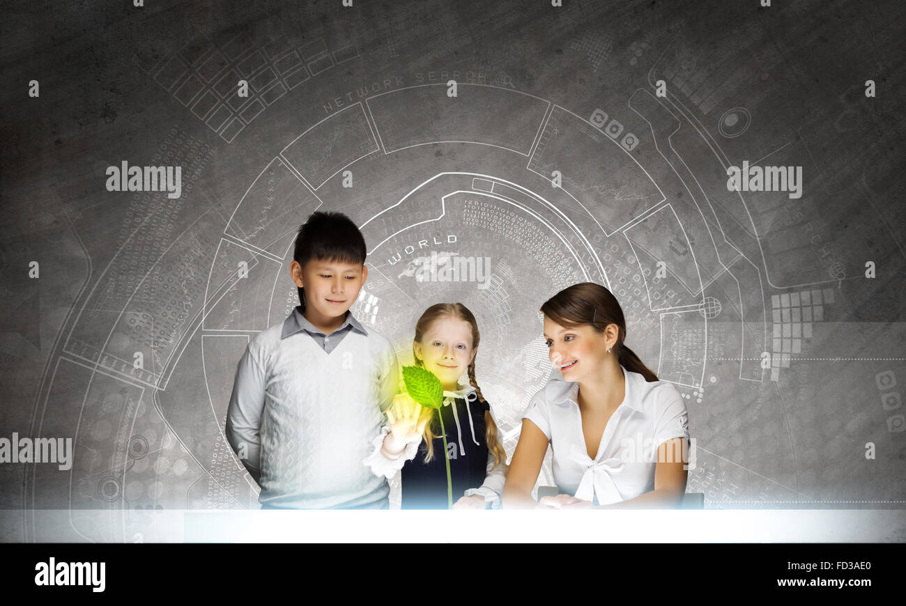 Young teacher and her pupils doing tests lesson Stock Photo - Alamy