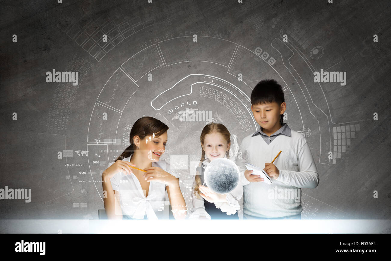 Young teacher and her pupils doing tests lesson Stock Photo - Alamy