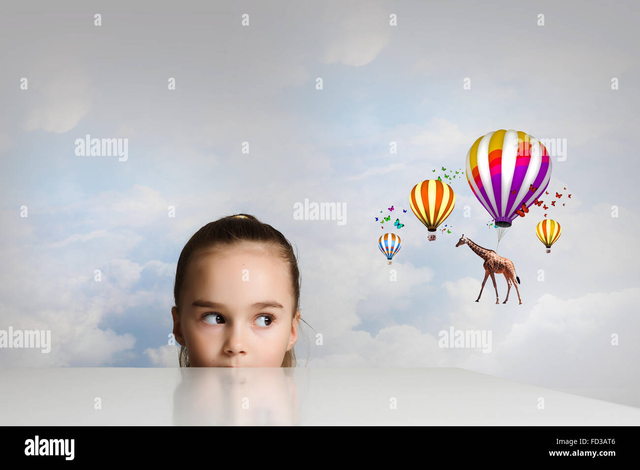 Little cute girl looking from under the table Stock Photo - Alamy