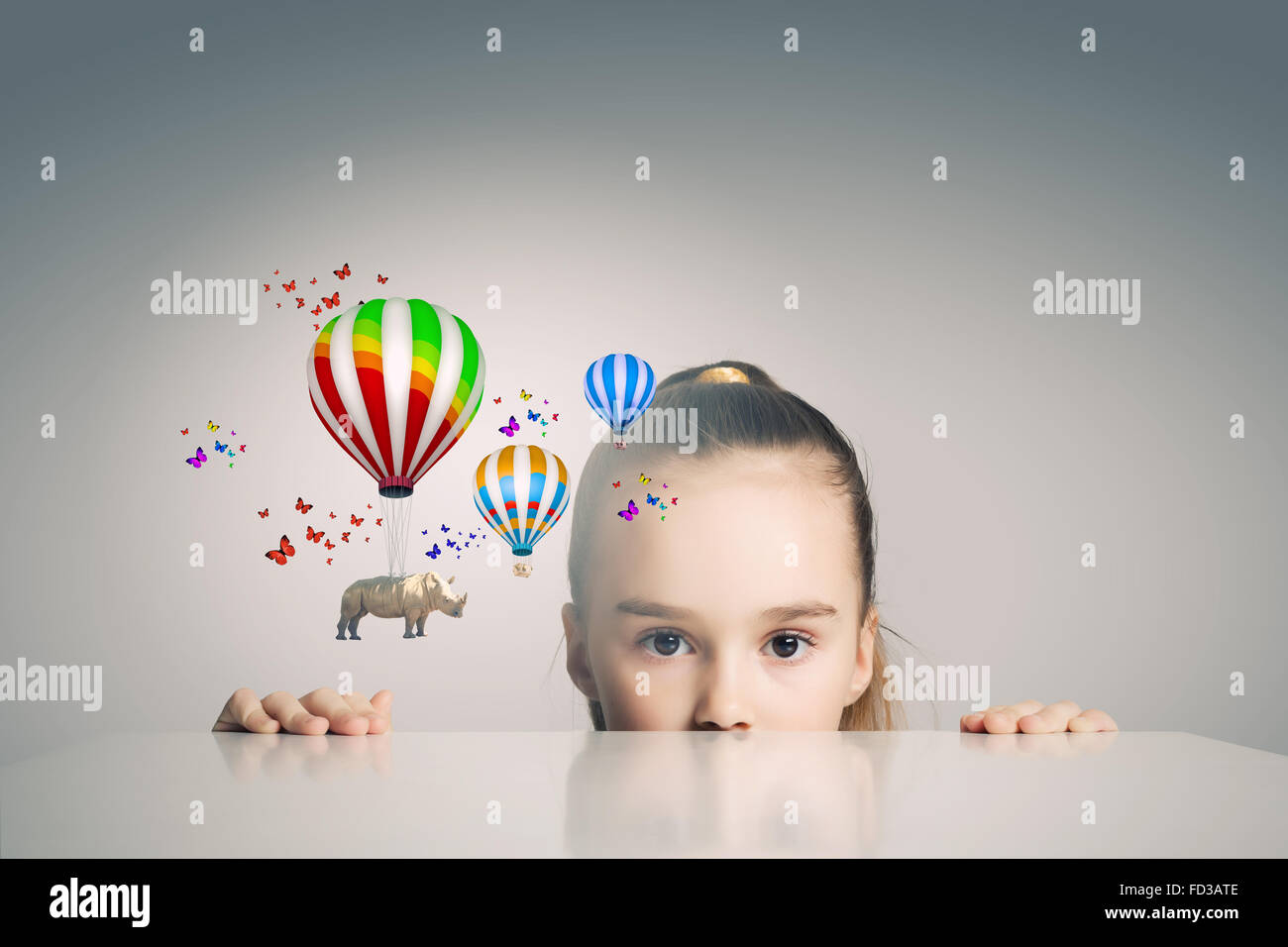Little cute girl looking from under the table Stock Photo - Alamy