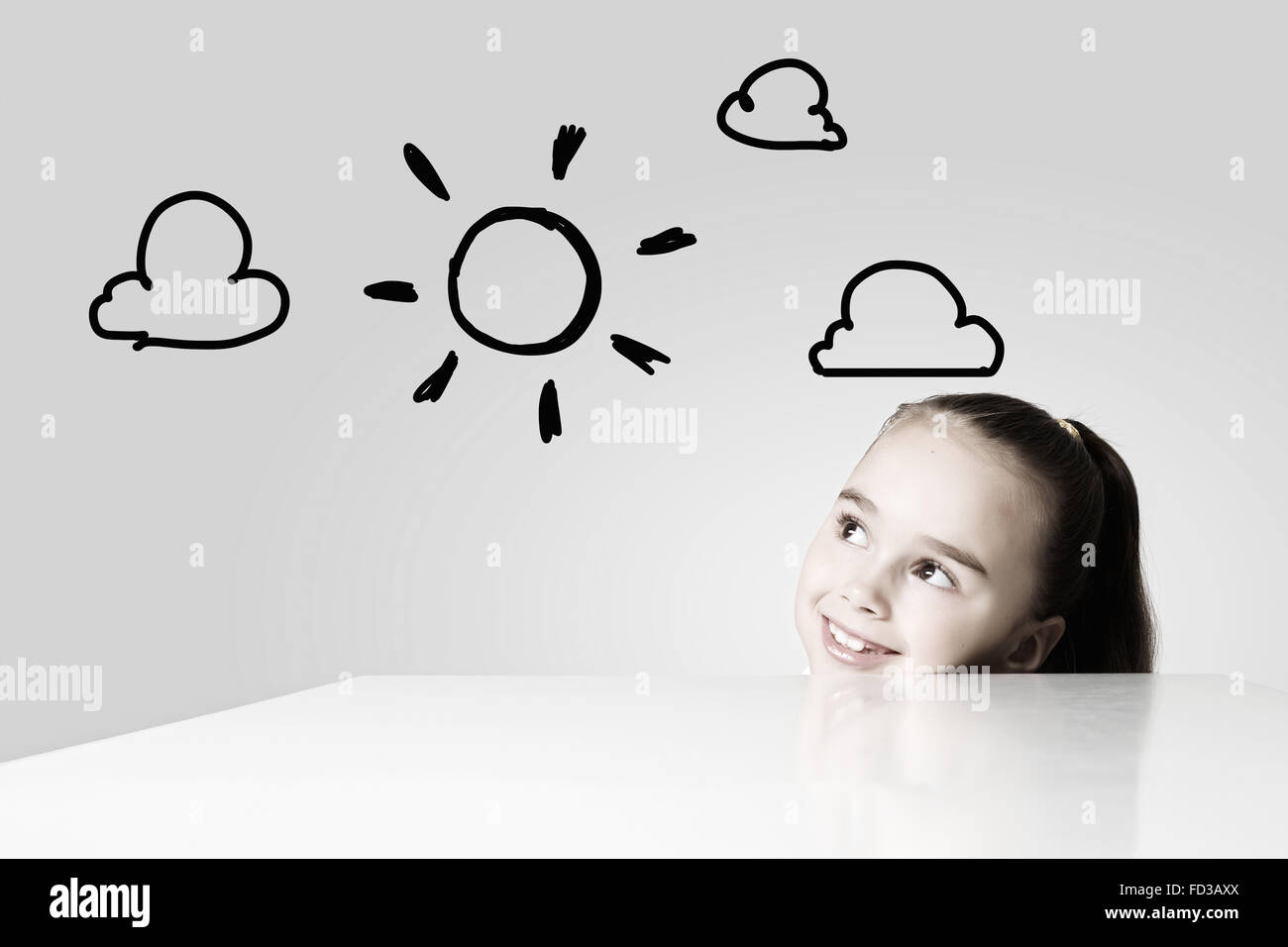 Little cute girl looking at drawing of sun Stock Photo - Alamy