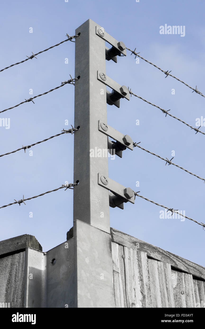 The corner of a barbed wire covered fence Stock Photo - Alamy