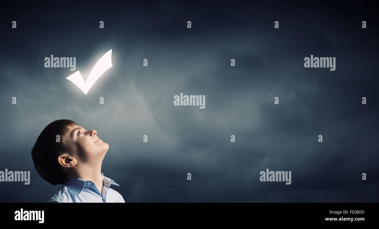 Cute boy looking at tick above his head Stock Photo - Alamy