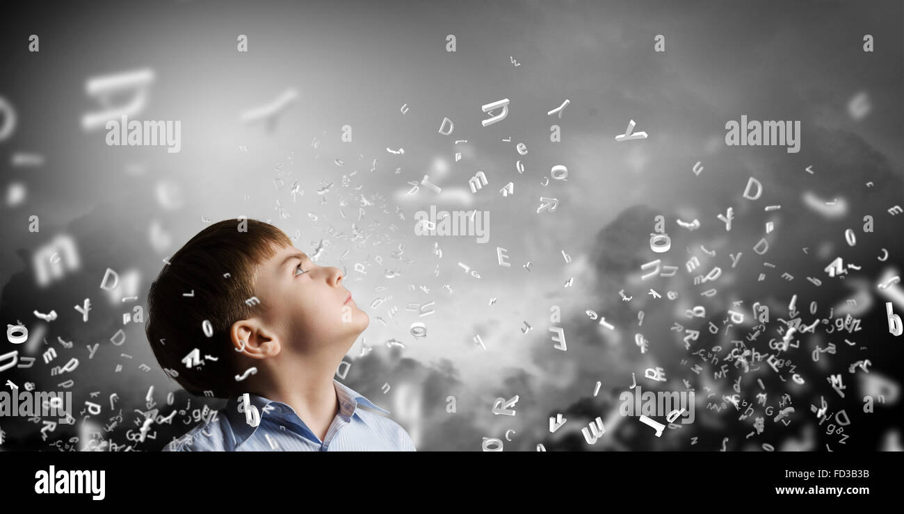 Cute boy of school age and letters flying around Stock Photo - Alamy