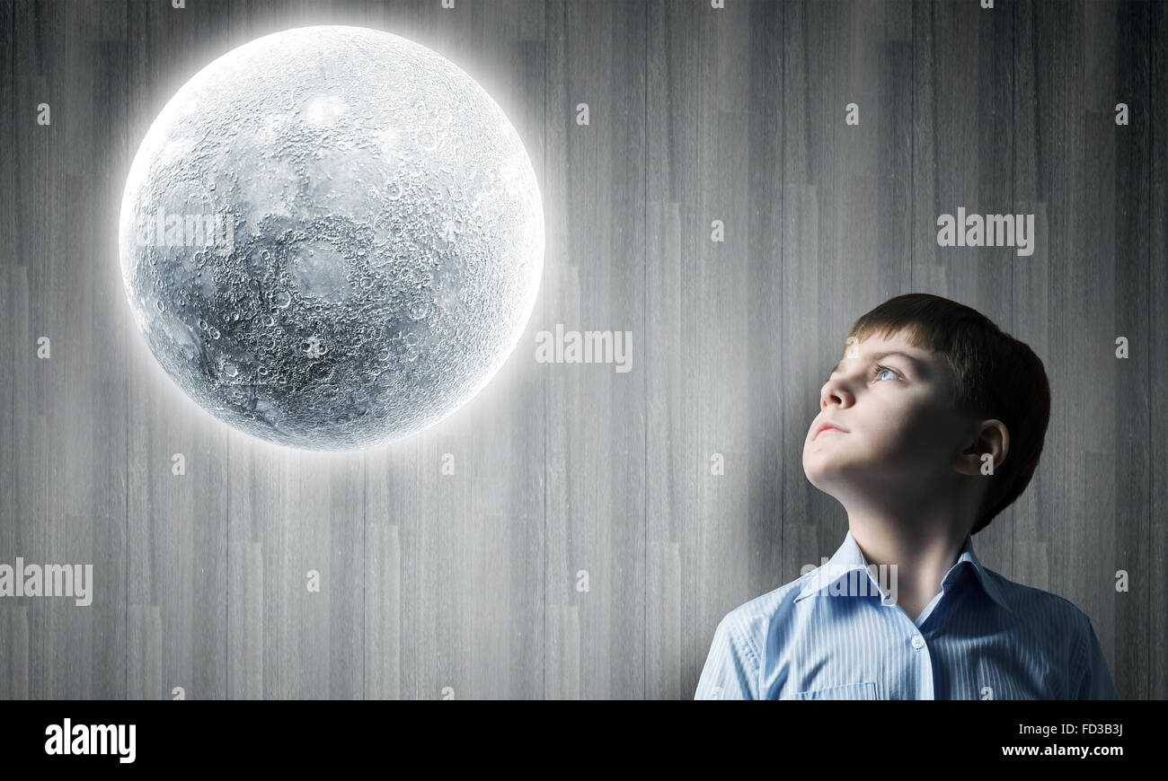 Cute boy of school age looking at moon Stock Photo - Alamy