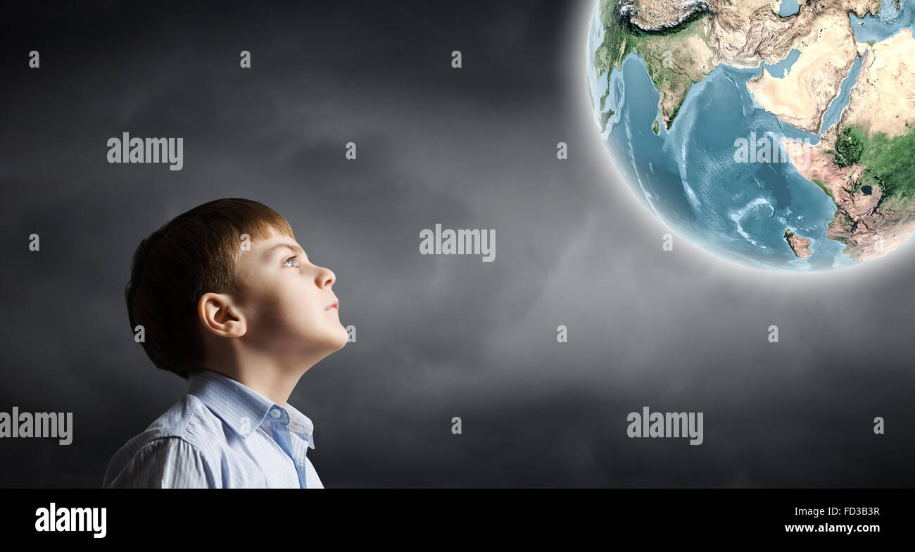 Little boy of school age looking at Earth planet. Elements of this ...